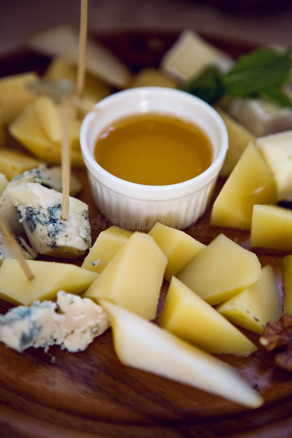 Different Sliced Cheese is on a Wooden Plate Stock Image - Image of ...