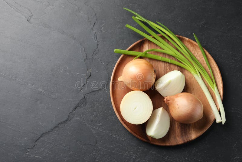 Different Sorts of Onion on Black Textured Table, Top View. Space for ...