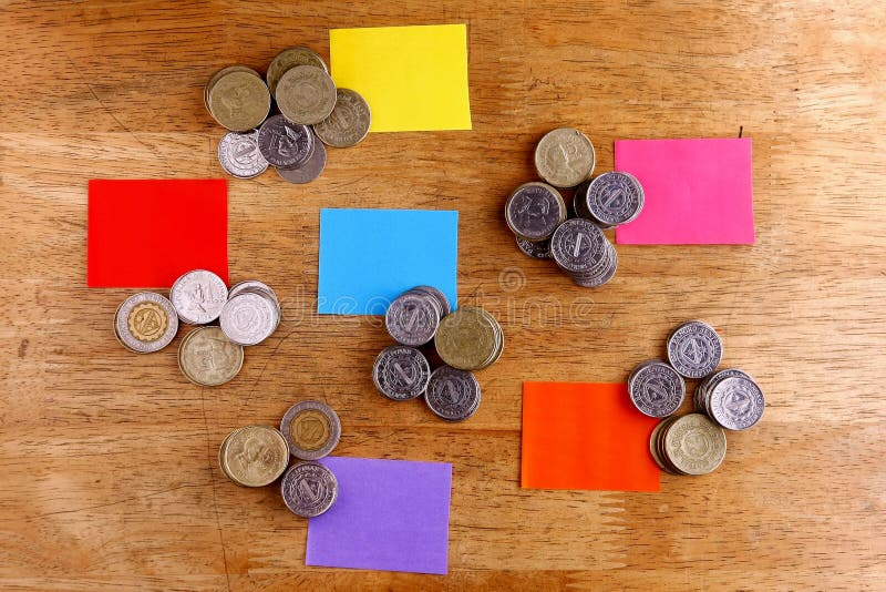 Different Stacks or Piles of Coins with Colored Paper Tags Stock Photo ...
