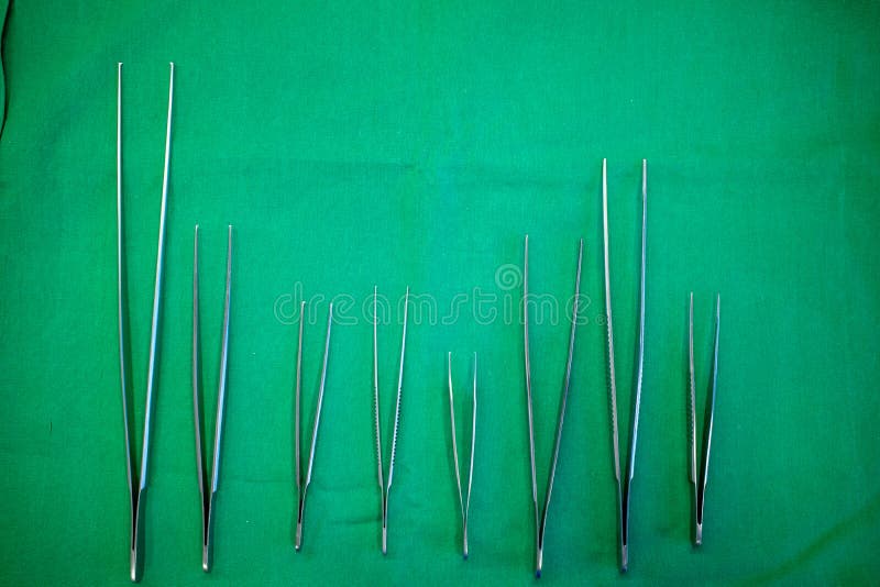 Some Different Surgical Forceps Lie Side by Side on a Surgical Drape ...