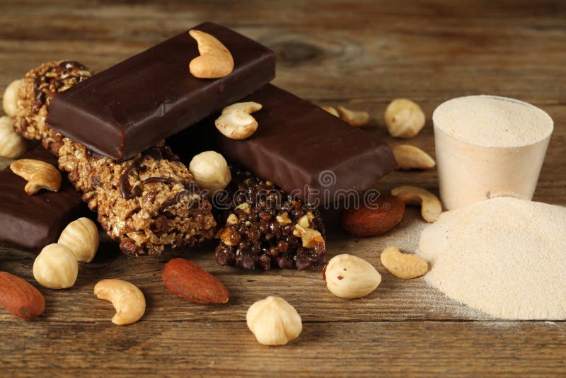 Different Tasty Bars, Nuts and Protein Powder on Wooden Table Stock ...