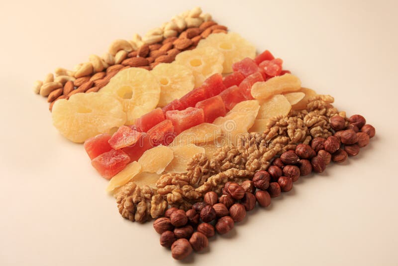 Different Tasty Nuts and Dried Fruits on Beige Background Stock Photo ...