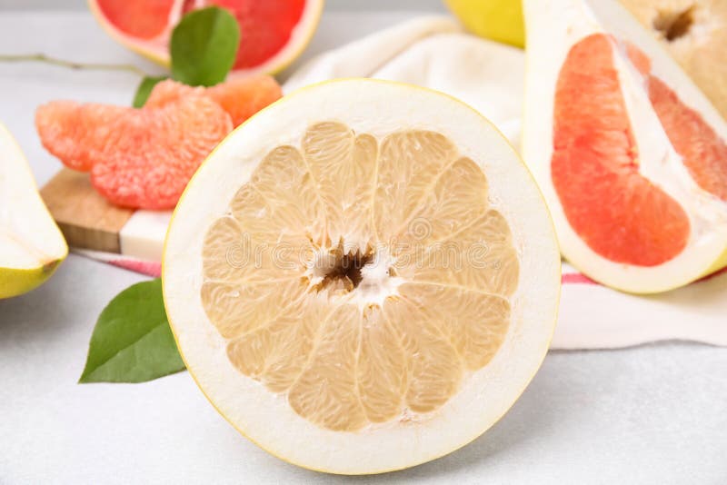 Different Tasty Pomelo Fruits on White Textured Table, Closeup Stock ...