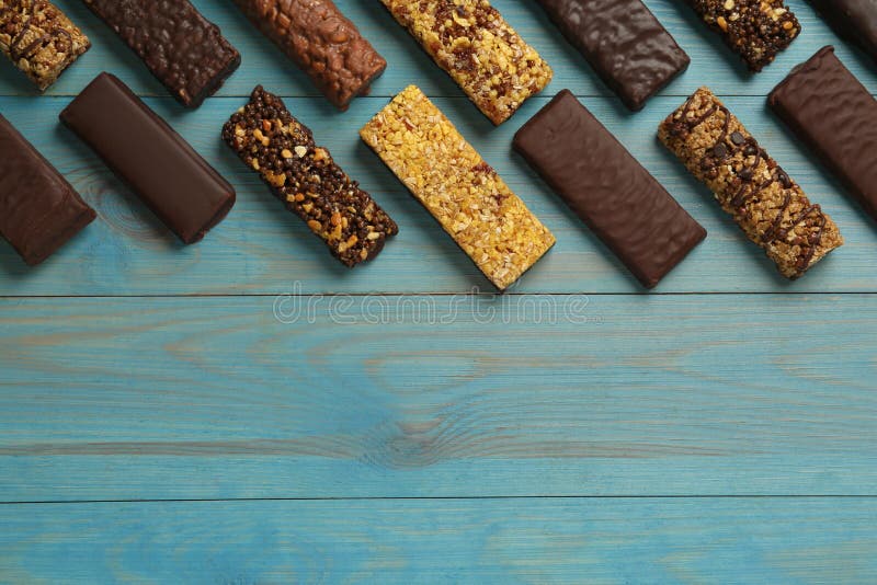 Different Tasty Protein Bars on Light Blue Wooden Table, Flat Lay ...