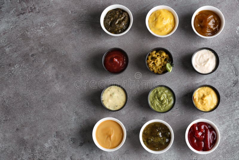 Different Tasty Sauces in Bowls on Grey Table Stock Photo - Image of ...