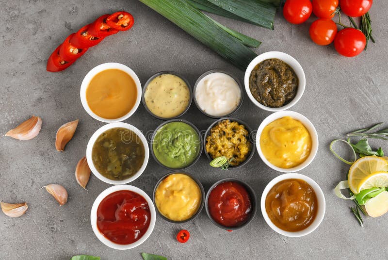 Different Tasty Sauces in Bowls on Grey Table Stock Photo - Image of ...