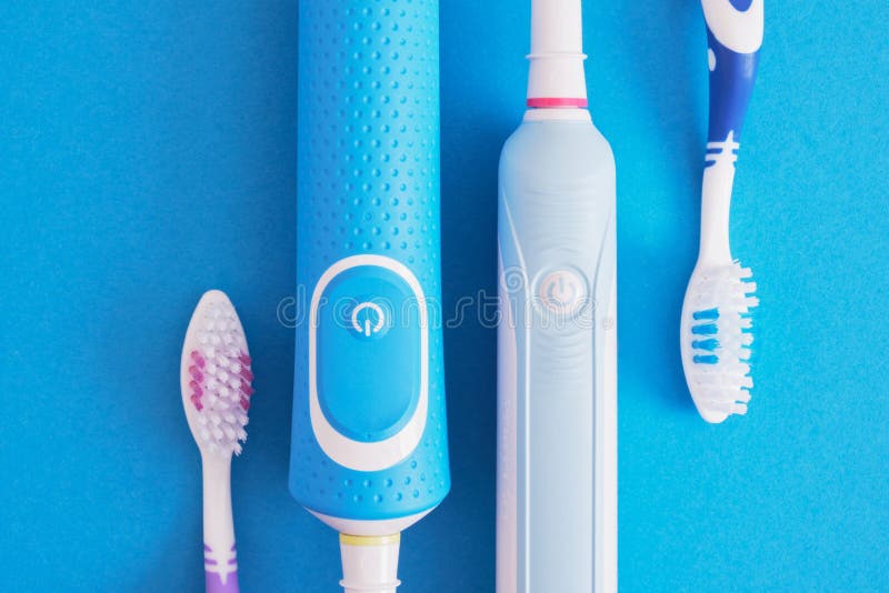 Different Toothbrushes on Blue Background, Electric Toothbrush or ...