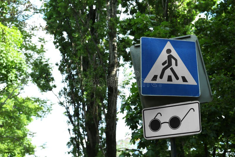 Different Traffic Signs Near Trees Outdoors, Space for Text Stock Photo ...