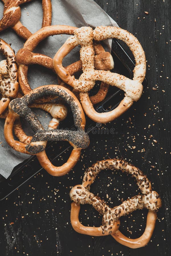 Different Types of Baked Pretzels with Seeds on a Black Background ...