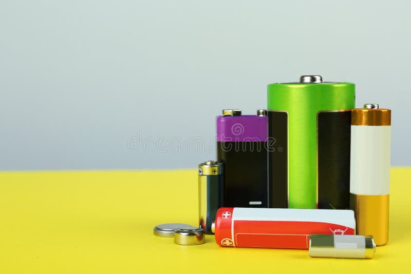 Different Types of Batteries on Color Background, Space for Text Stock ...