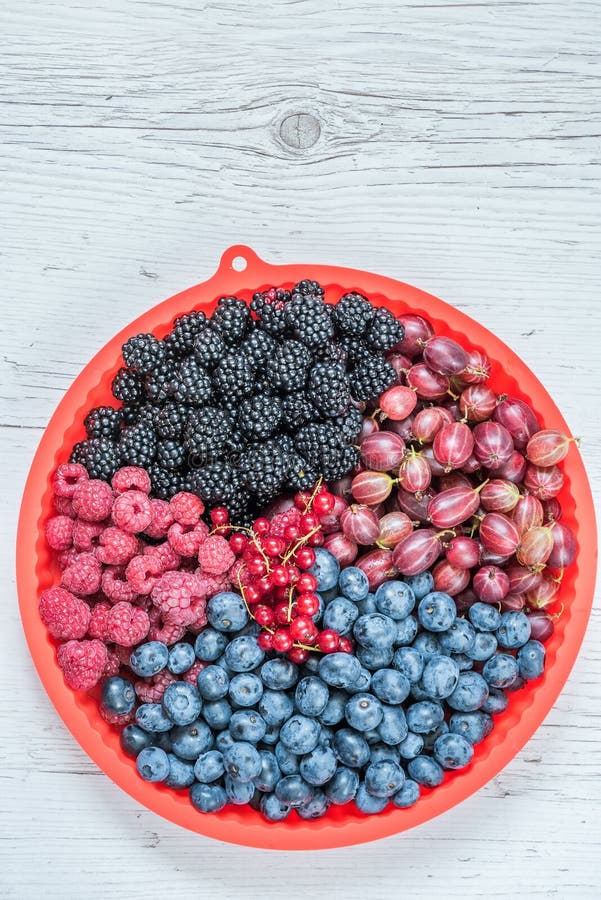 Different Types of Berries on a Red Plate. Stock Photo - Image of view ...
