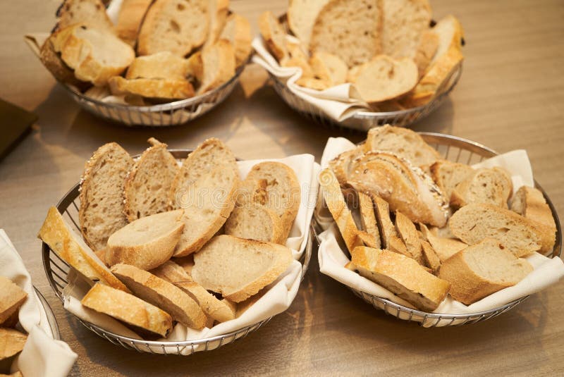 Different Types of Bread in the Basket on a Wooden Table Background ...