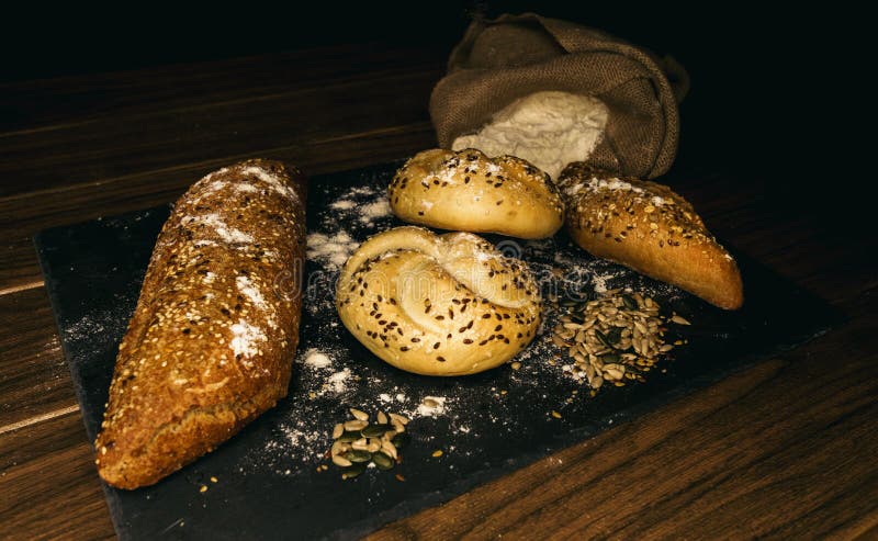 Different Types of Bread on a Slate Board on a Black Background Stock ...