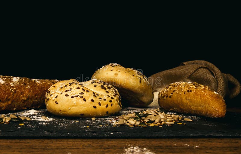 Different Types of Bread on a Slate Board on a Black Background Stock ...