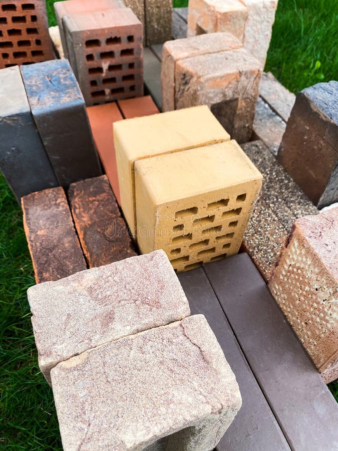 Different Types of Bricks Stacked Beautifully on Green Grass Stock ...