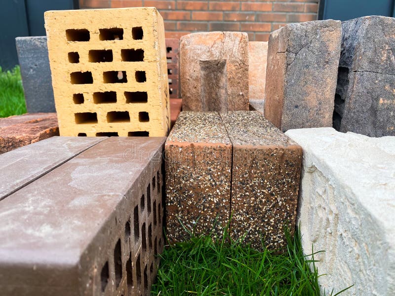 Different Types of Bricks Stacked Beautifully on Green Grass Stock ...