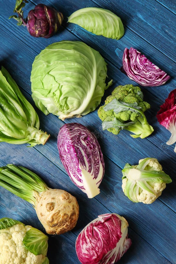 Different Types of Cabbage on Color Wooden Background Stock Photo ...