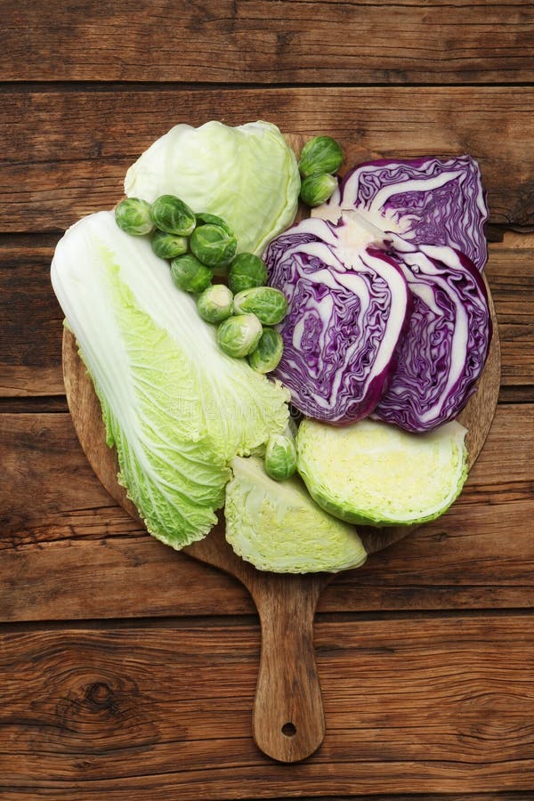 Different Types of Cabbage on Wooden Table, Top View Stock Photo ...