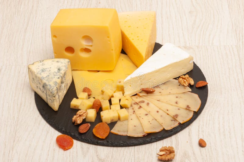 Different Types of Cheese on a Black Graphite Board Decorated with ...