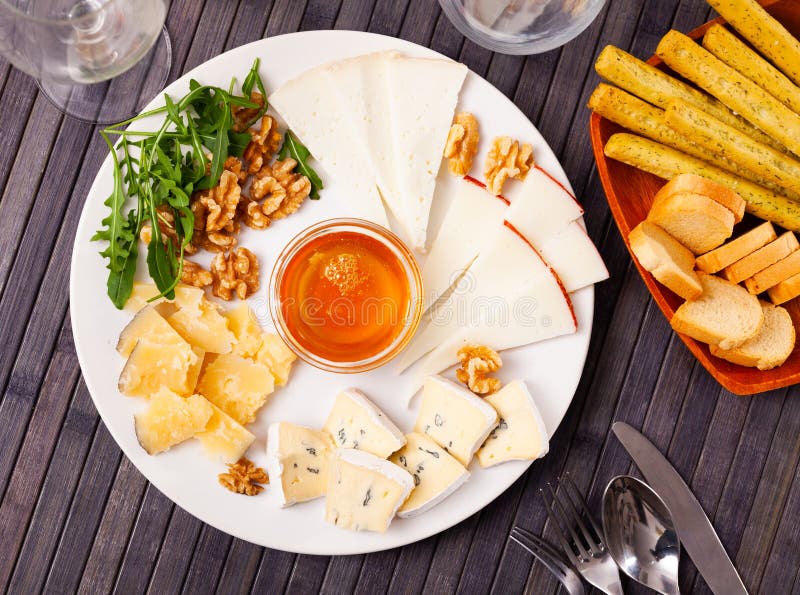 Different Types of Cheese Sliced and Served on Plate with Bowl of Honey ...