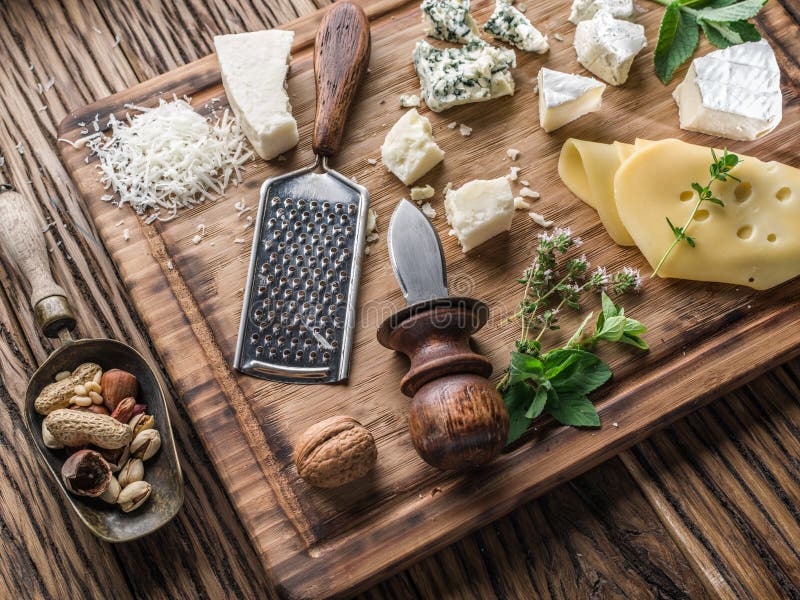 Different Types of Cheeses with Nuts and Herbs. Stock Photo - Image of ...