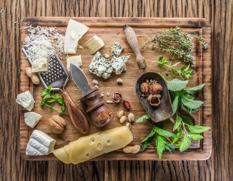 Different Types of Cheeses with Nuts and Herbs. Stock Image - Image of ...