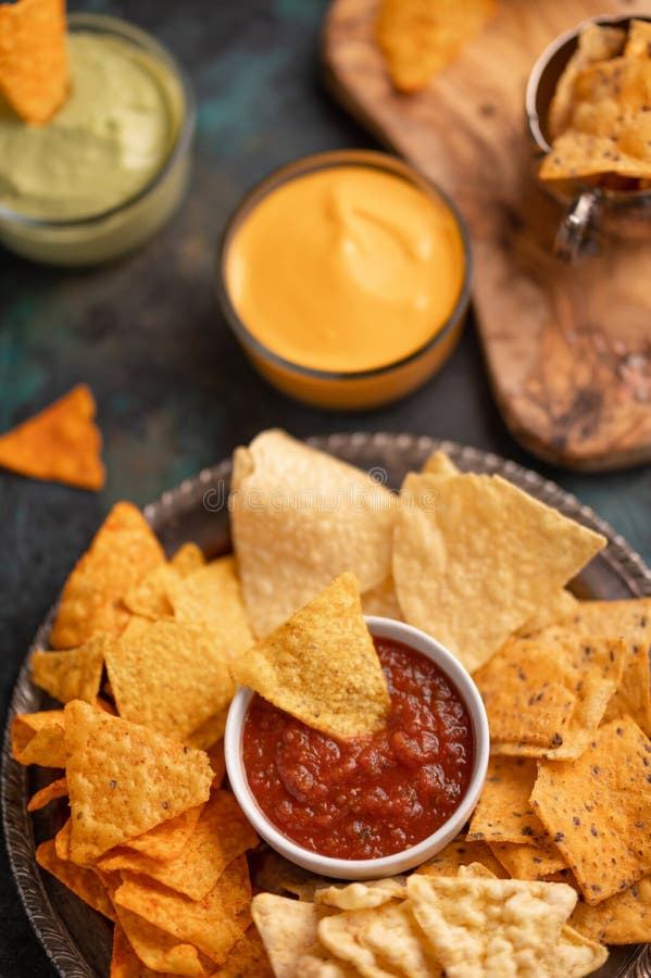 Different Types of Chips with Dressings and Dip and Salsa, Close-up ...