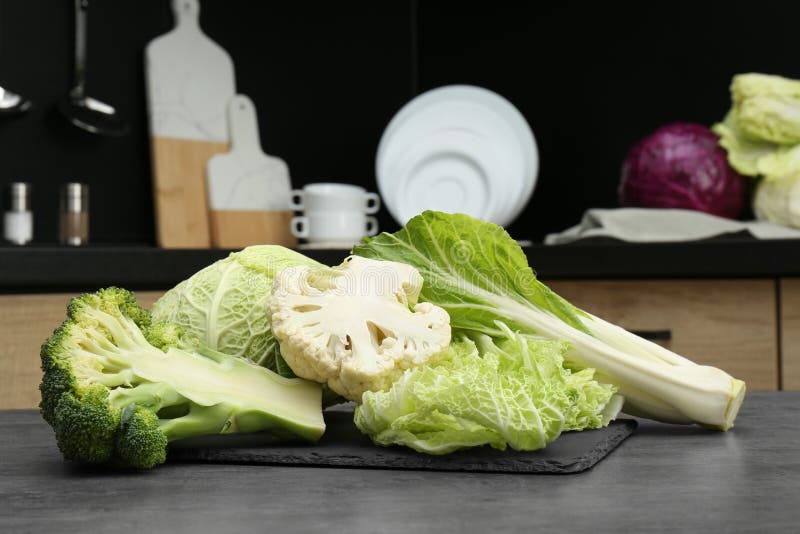 Different Types of Cut Cabbage on Grey Table in Kitchen Stock Photo ...
