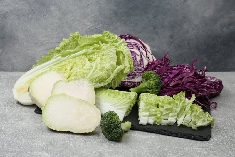 Different Types of Cut Cabbage on Light Grey Table Stock Photo - Image ...