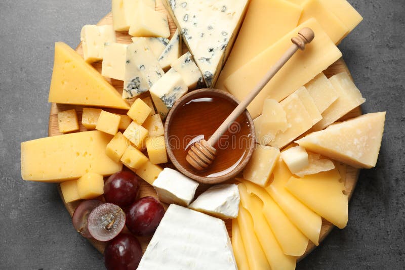 Different Types of Delicious Cheese and Snacks Served on Grey Table ...