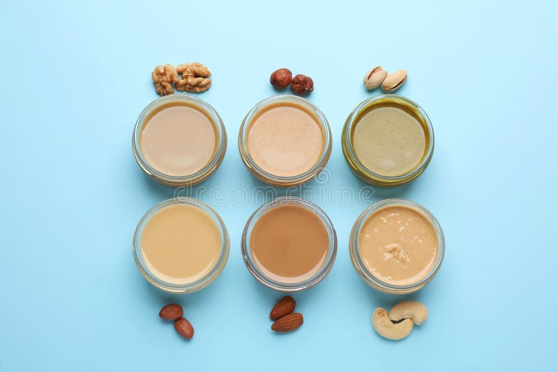 Different Types of Delicious Nut Butters and Ingredients on Light Blue ...