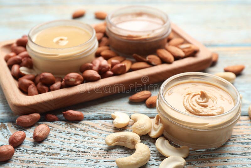 Different Types of Delicious Nut Butters and Ingredients on Light Blue ...