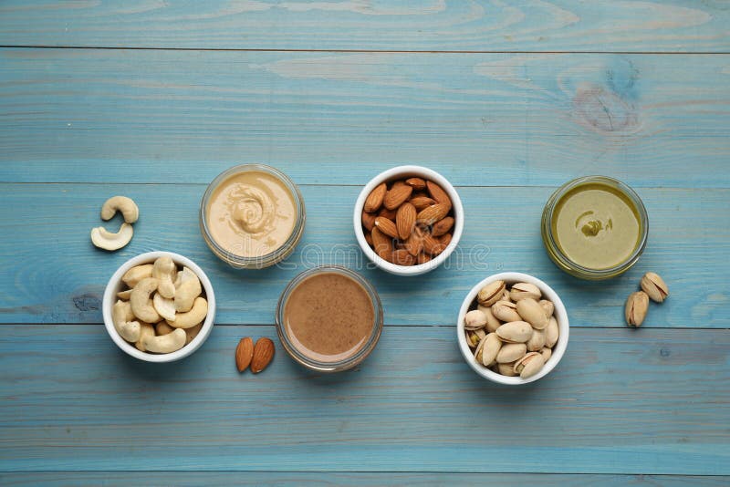 Different Types of Delicious Nut Butters and Ingredients on Blue Wooden ...