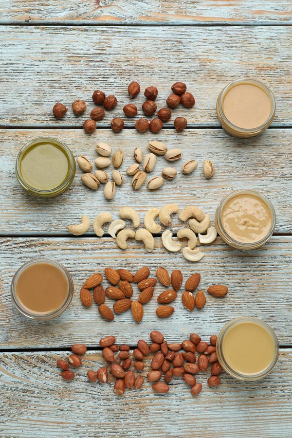 Different Types of Delicious Nut Butters and Ingredients on Blue Wooden ...