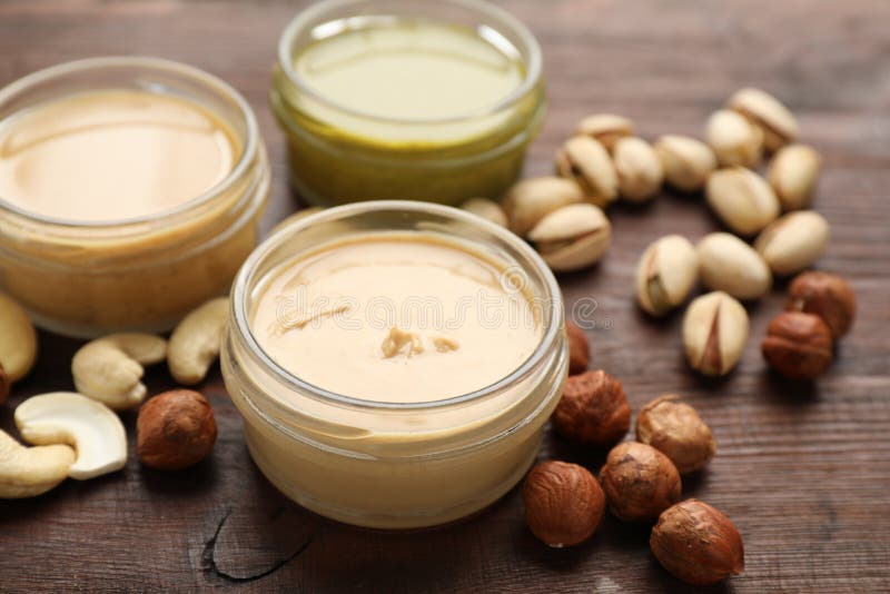 Different Types of Delicious Nut Butters and Ingredients on Wooden ...