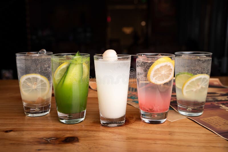Different Types of Drinks Lined Up on a Wooden Table with Magazines ...
