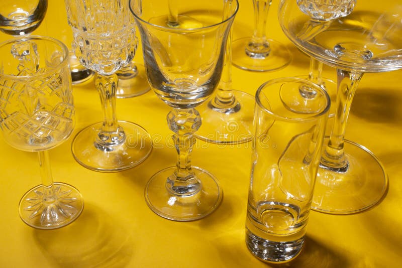 Different Types of Empty Glasses on Yellow Background Stock Photo ...