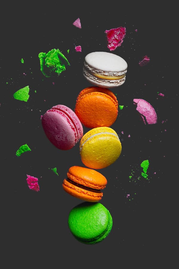 Different Types of Macaroons in Motion Falling on Black Background ...