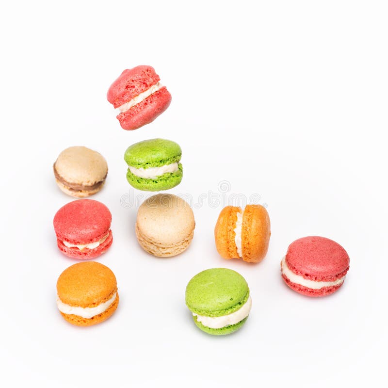 Different Types of Macaroons in Motion Falling on White Background ...
