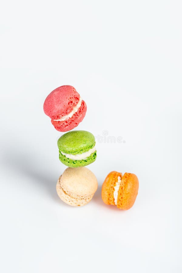 Different Types of Macaroons in Motion Falling on White Background ...