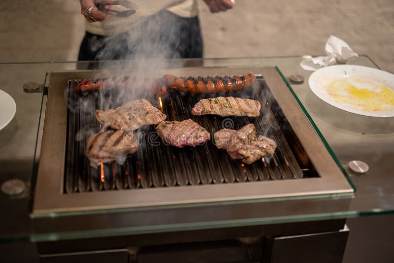 Different Types of Meat, Beef Steaks and Pork Sausages, Cooked on a ...