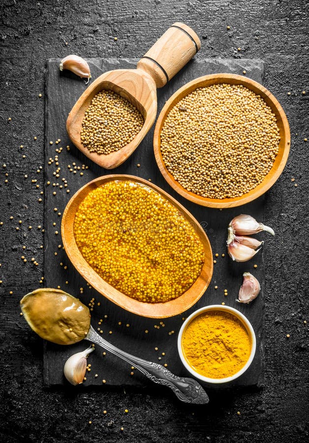 Different Types of Mustard on a Stone Board with Garlic Stock Photo ...