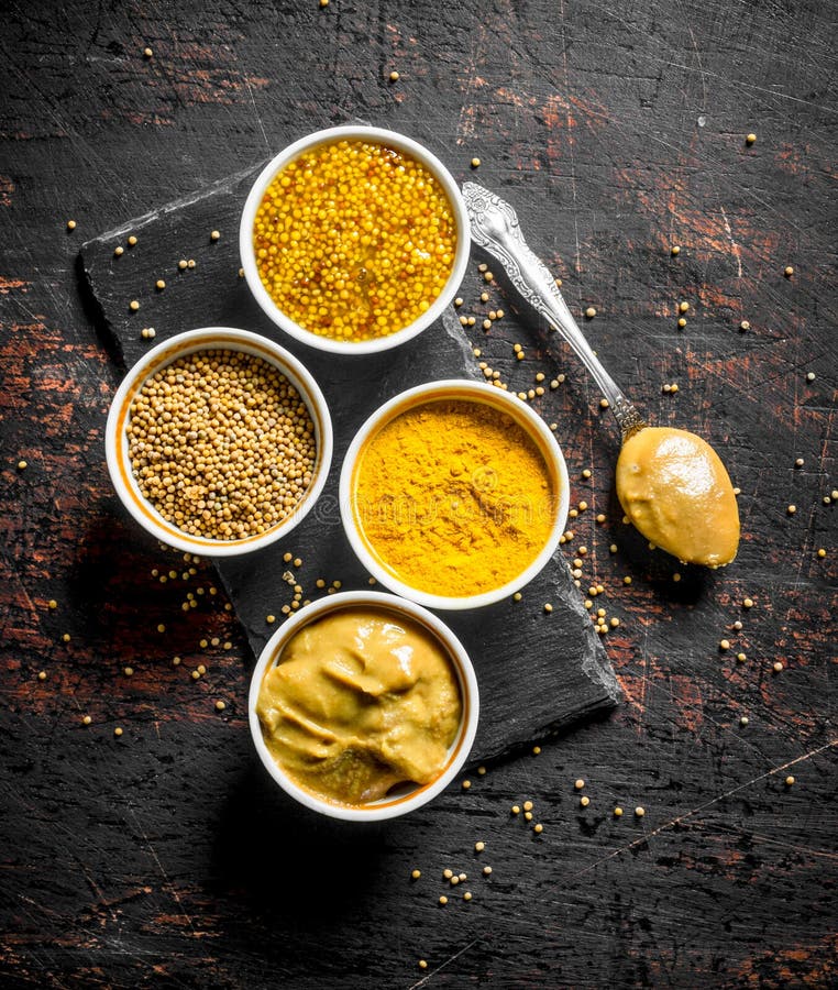Different Types of Mustard on a Stone Board with a Spoon Stock Image ...