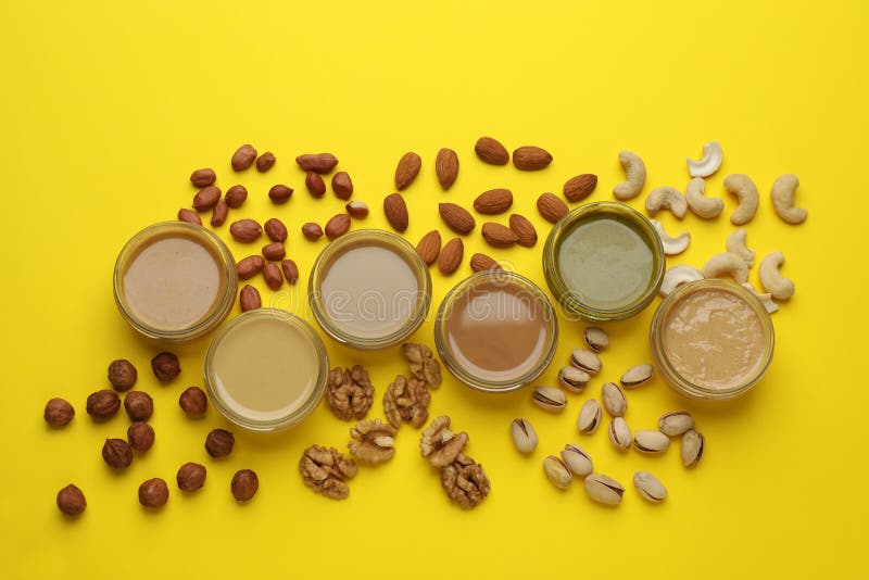 Different Types of Nut Butter and Ingredients on Yellow Background ...