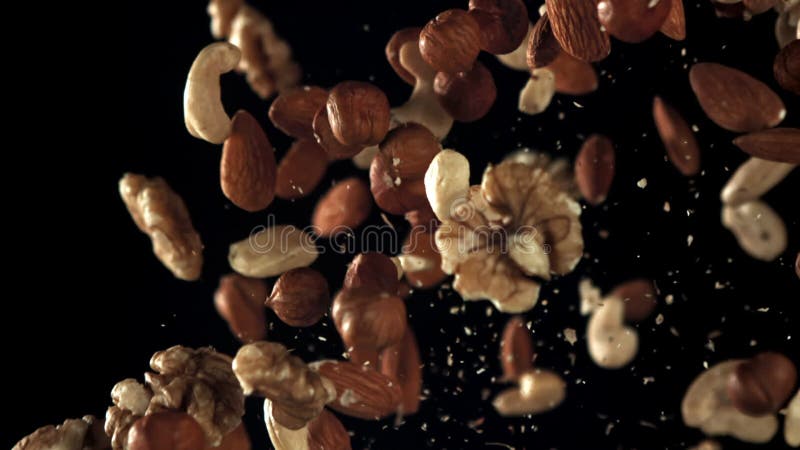 Different Types of Nuts Fly Up and Fall Down. Filmed on a High-speed ...