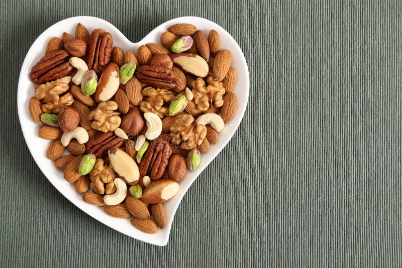 Nuts on a Plate in the Shape of a Heart. Stock Photo - Image of ...