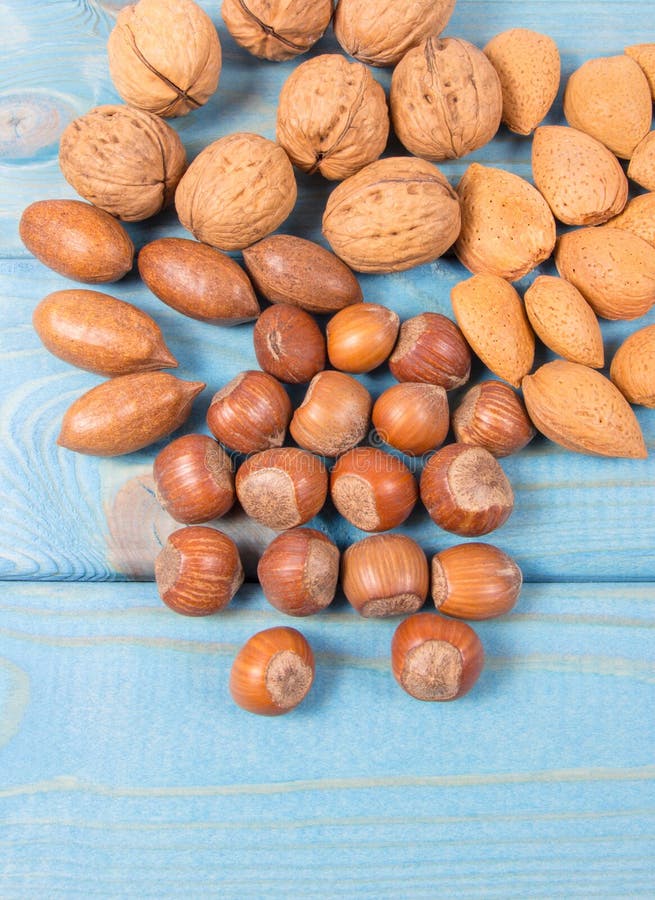 Different Types of Nuts in a Shell on a Wooden Background. Stock Image ...