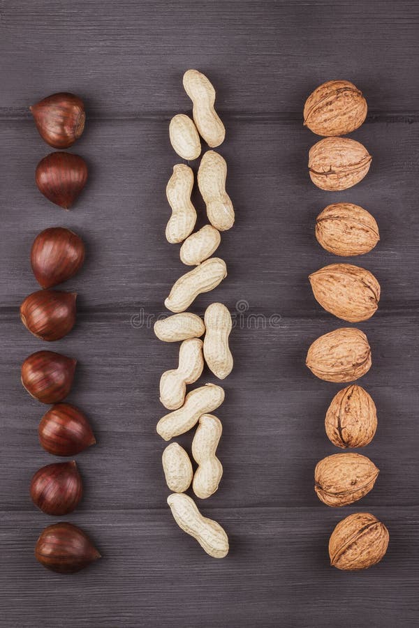 Different Types of Nuts: Walnut, Peanut, Chestnut on Wooden Stock Image ...