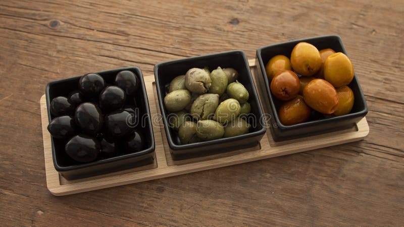 Different Types of Olives in Three Square Black Containers Stock Photo ...