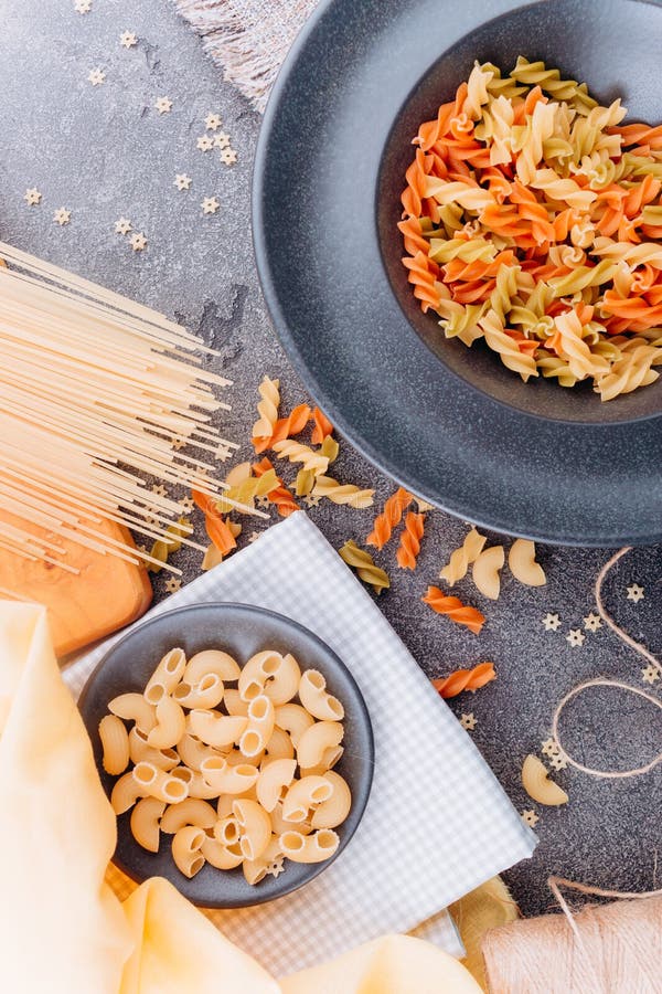 Different Types of Pasta on a Black Plate Top View Stock Image - Image ...